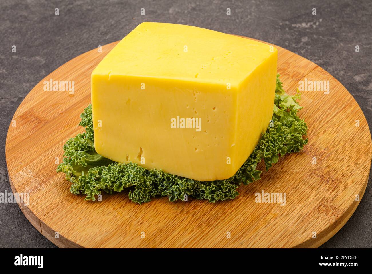 Yellow tilsiter cheese dairy product brick Stock Photo - Alamy