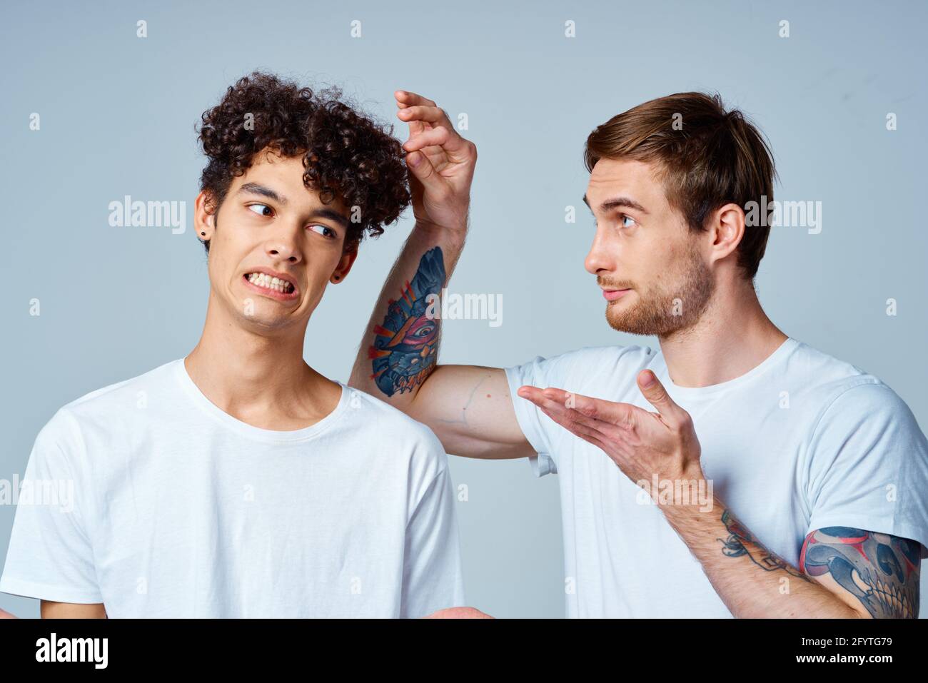 Two young friends wearing t shirts hi-res stock photography and images - Alamy
