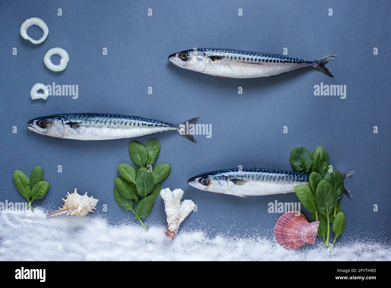 Delicious fresh fish on blue background. Fish with aromatic herbs ...