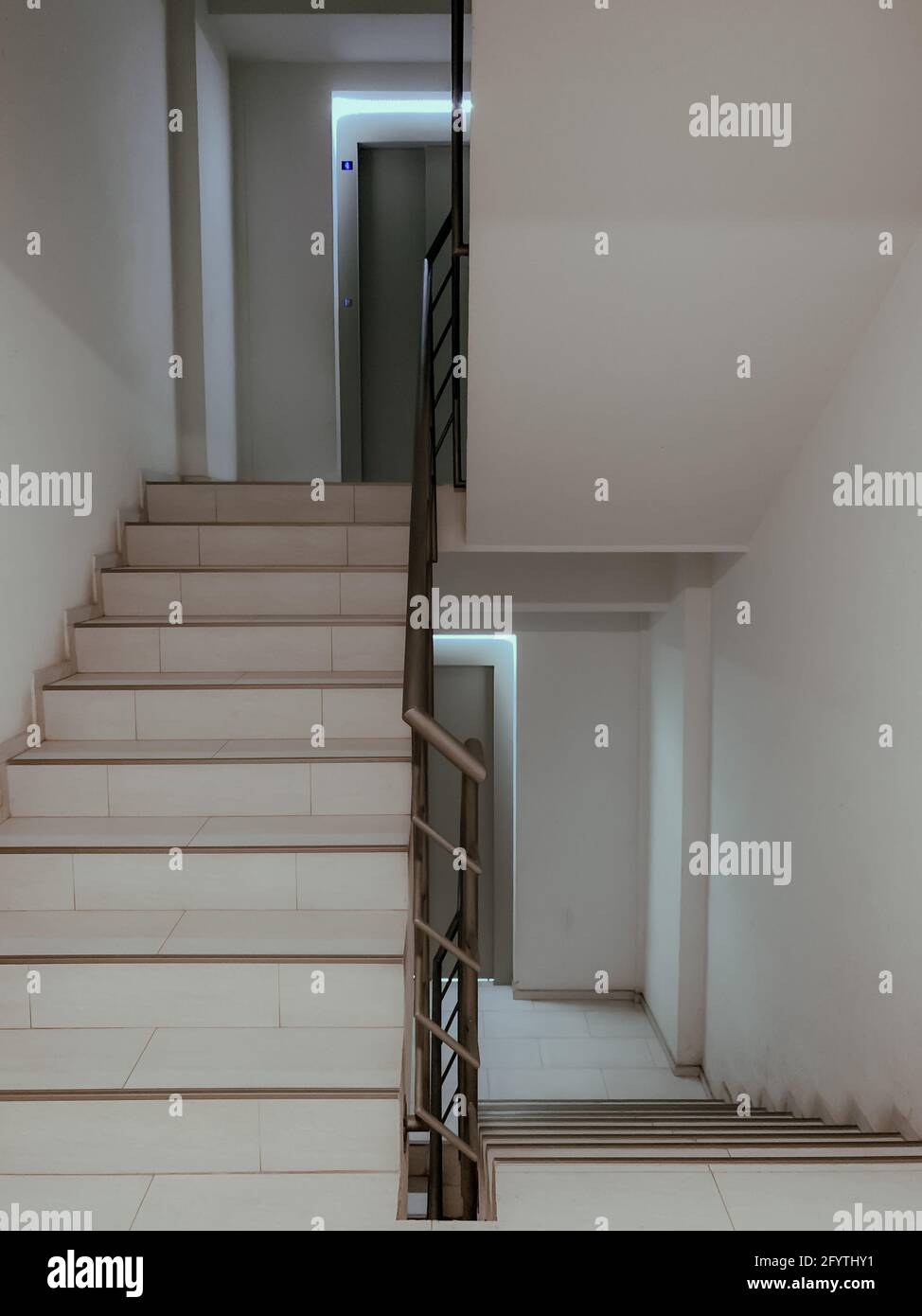 A vertical shot of the staircase inside of a modern apartment building ...