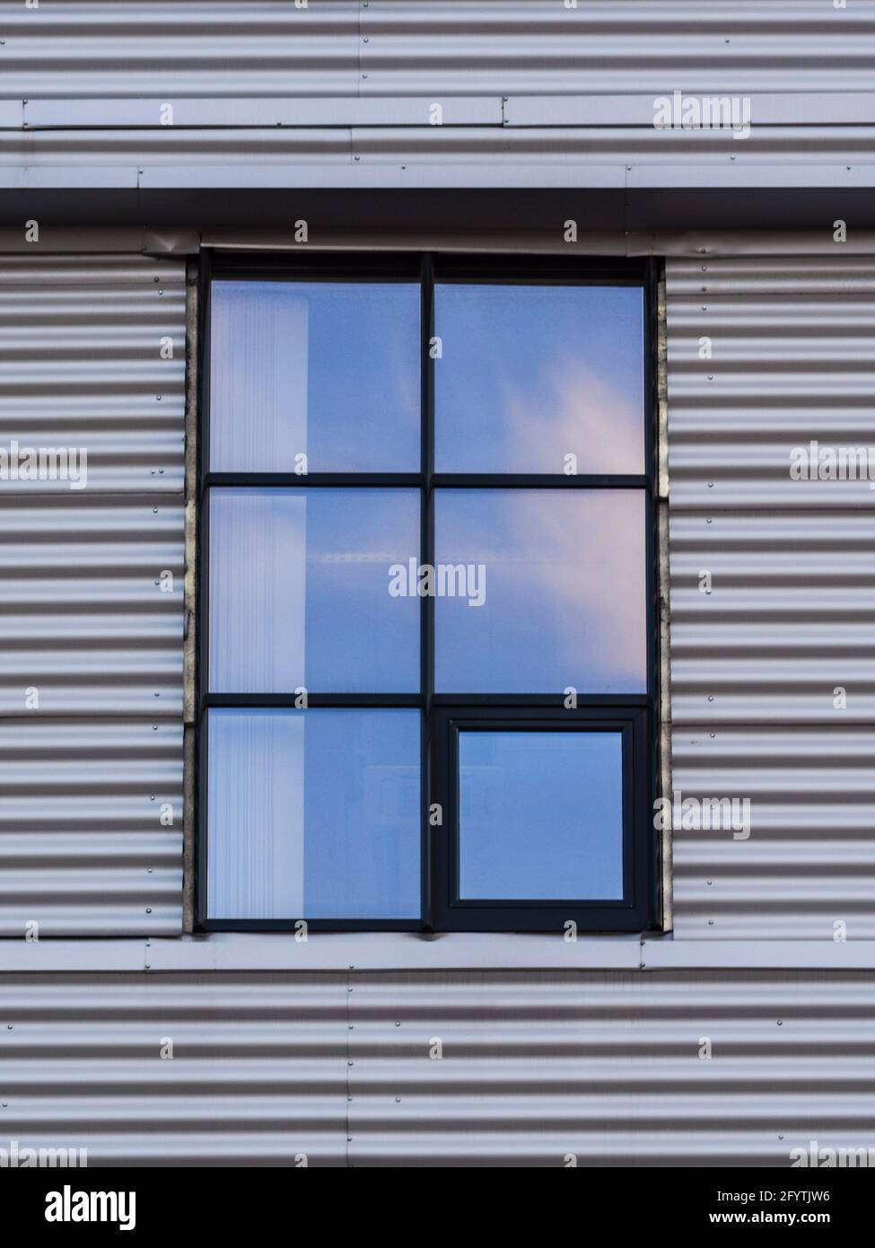 A vertical shot of a modern building with a clean glass window Stock ...
