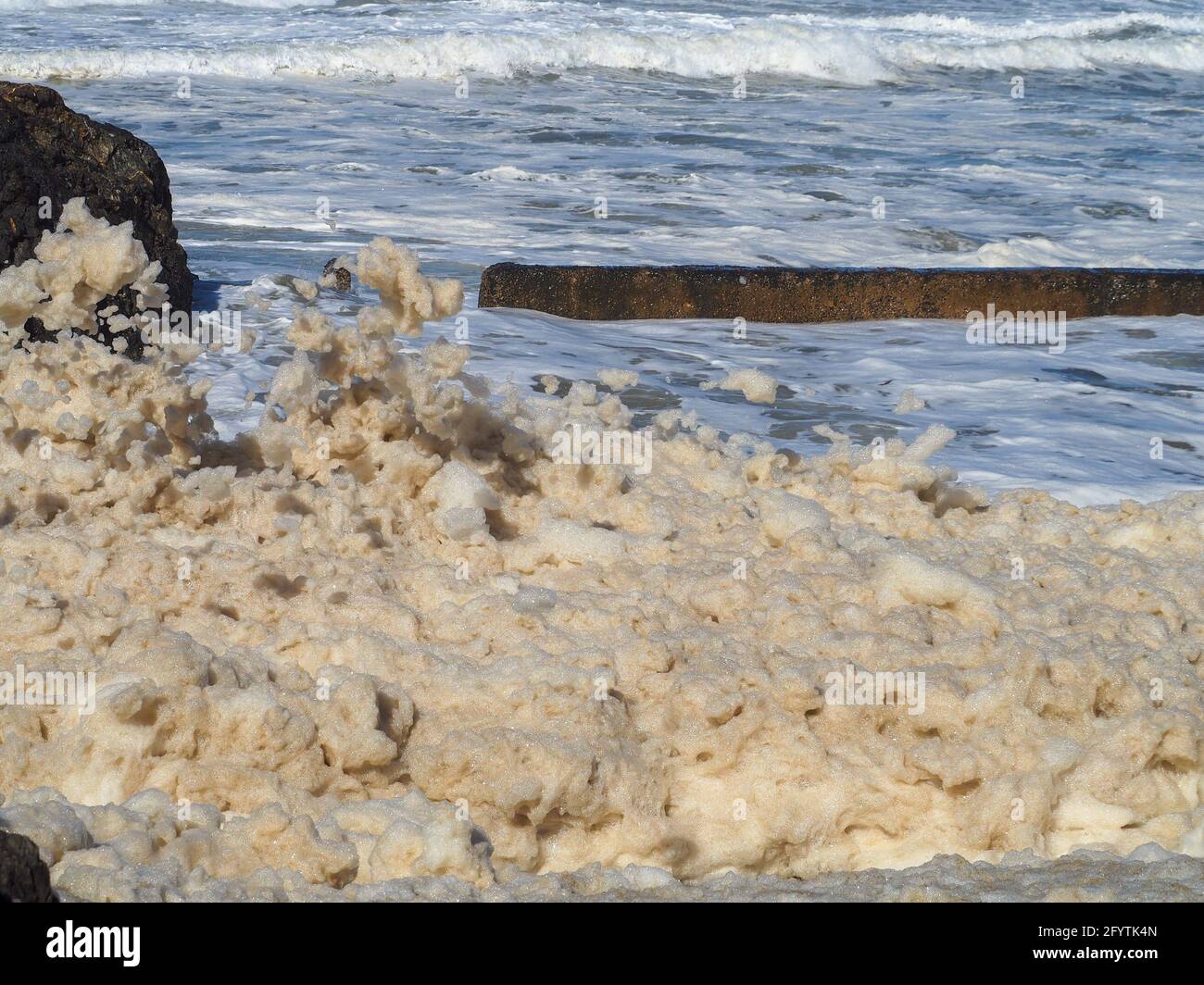 The strong wind is blowing and Bubbly sea foam is flying up into the ...