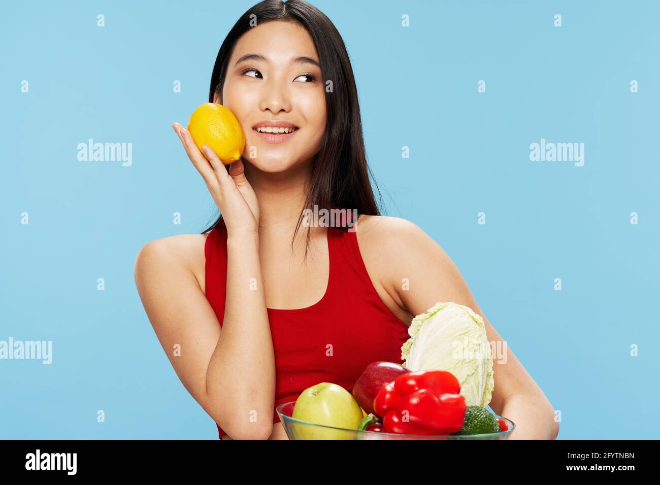 woman asian appearance vegetables in hands healthy food lifestyle blue ...