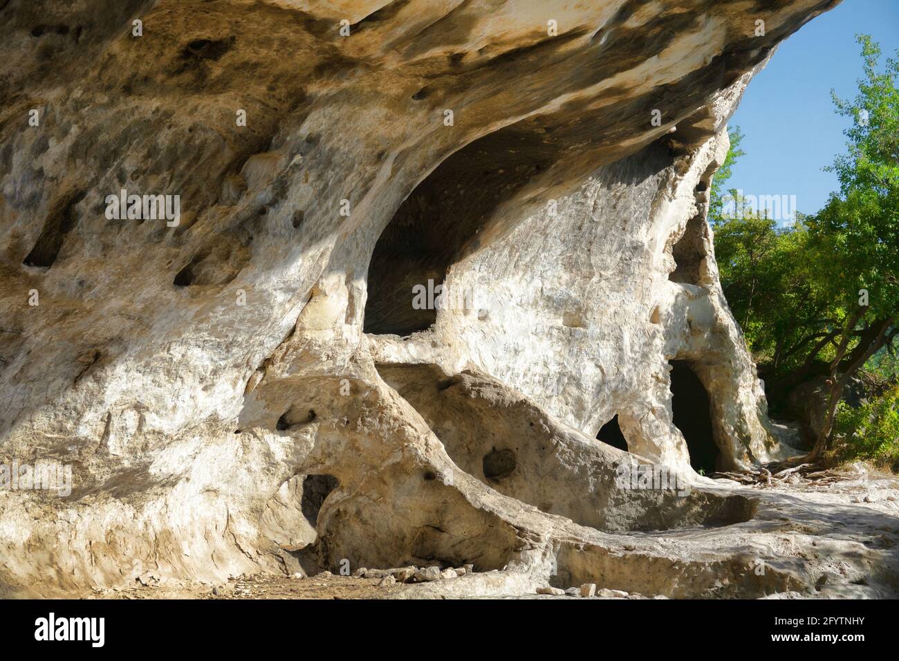 Entrance to a man-made cave in a limestone rock. A place of refuge for ...