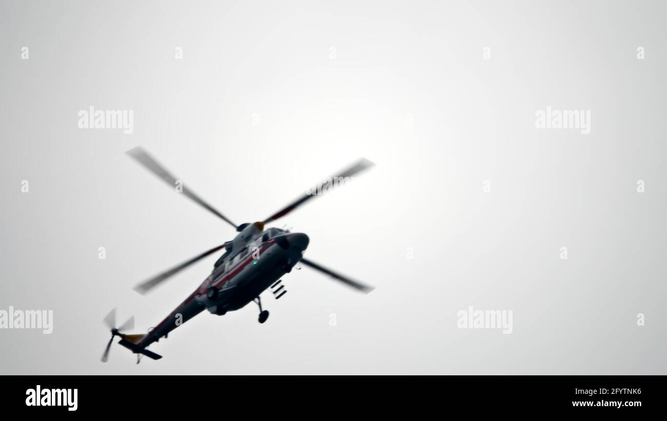 Rescue helicopter with a lowered ramp (safety ladder). Blurred ...