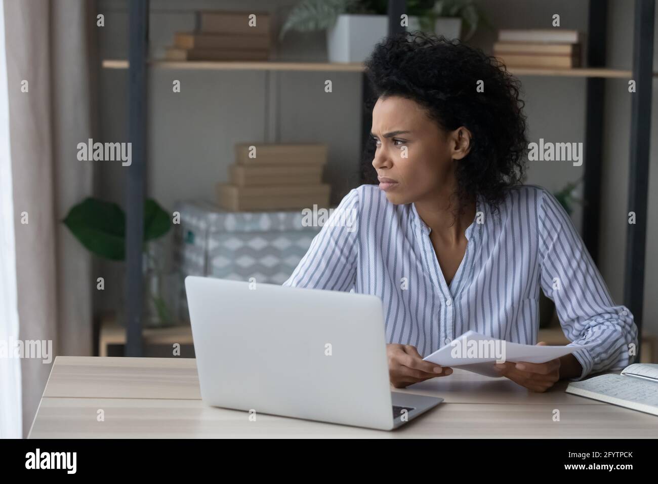 Unhappy African American woman bored with computer work Stock Photo - Alamy
