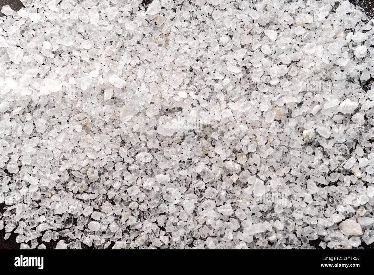 selective focus. food background. coarse sea salt in crystals. white ...