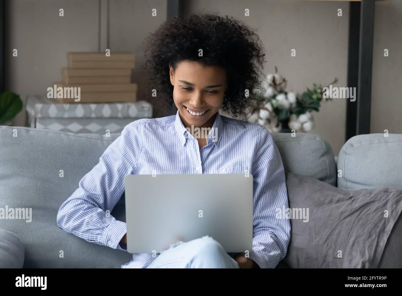 Smiling African American woman use computer at home Stock Photo - Alamy