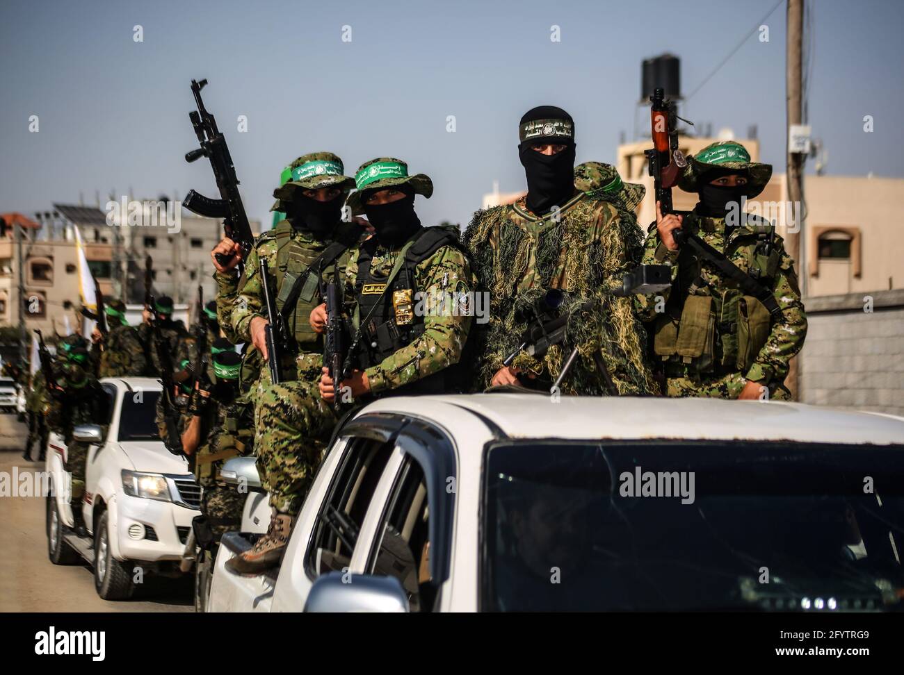 Masked gunmen from the Izz al-Din al-Qassam Brigades take part during ...