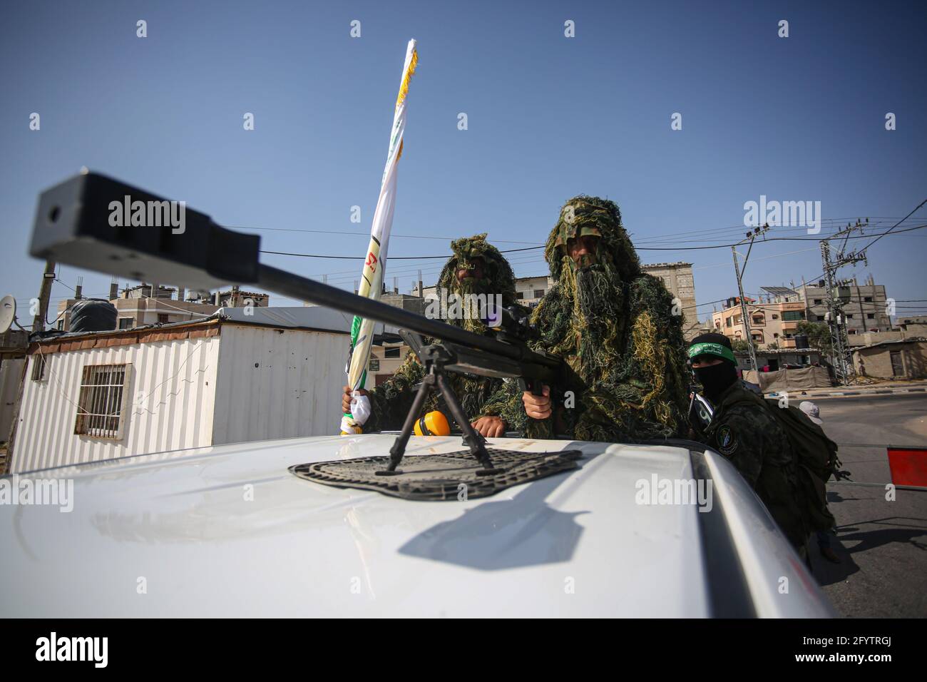 Masked gunmen from the Izz al-Din al-Qassam Brigades take part during ...