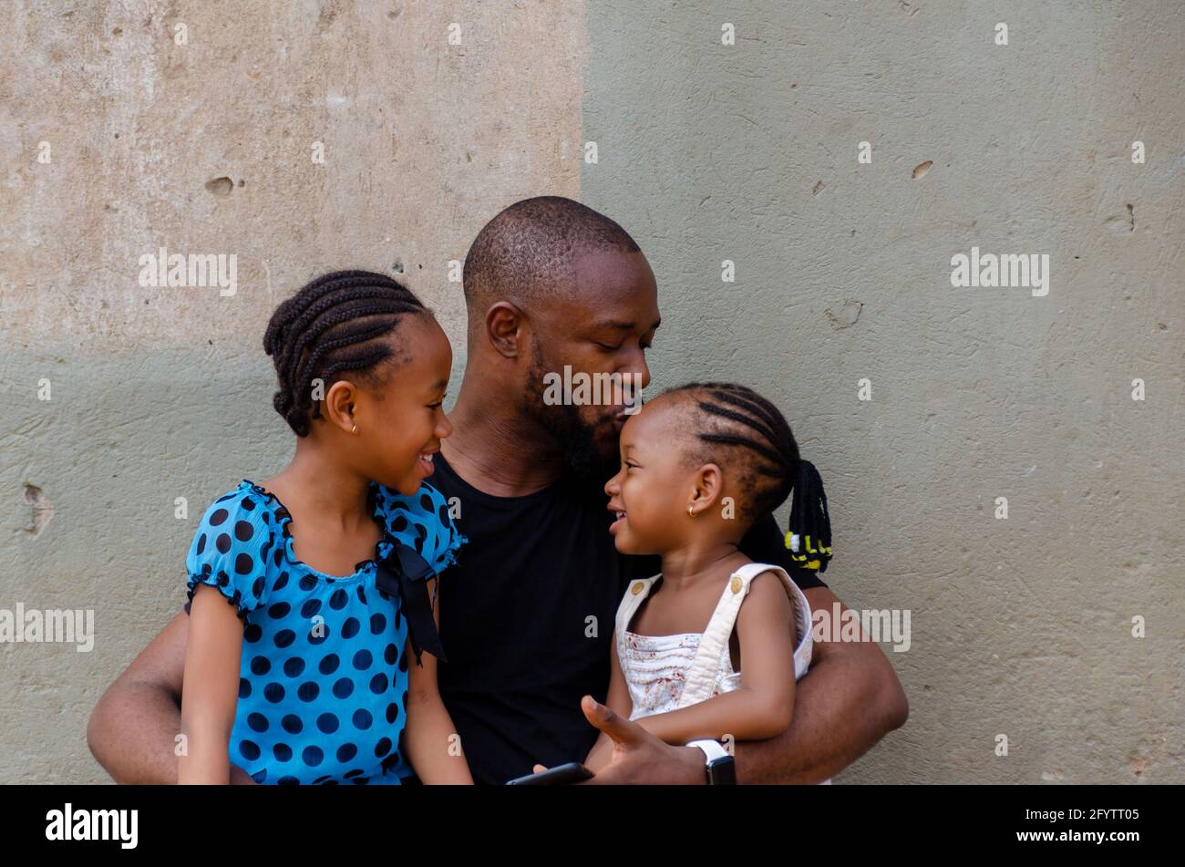 beautiful african kids feeling excited as their father kissed them ...