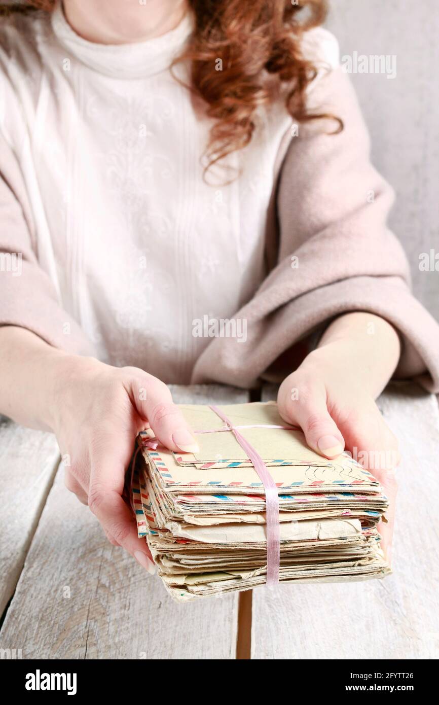 Young woman holding old letters. Retro style Stock Photo - Alamy