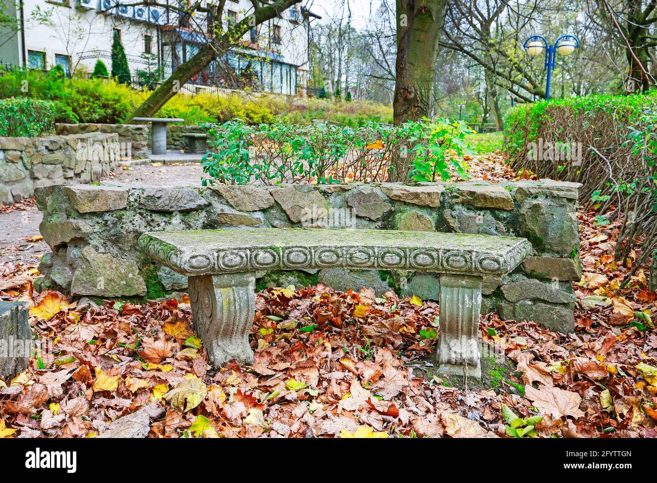 Old stone bench in autumn park. Relax place Stock Photo - Alamy