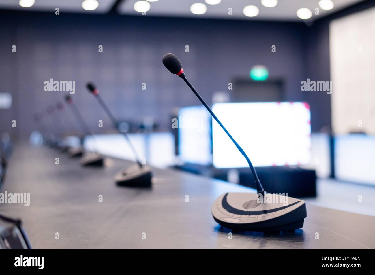 Close-up of microphones in an empty meeting room at a press conference ...