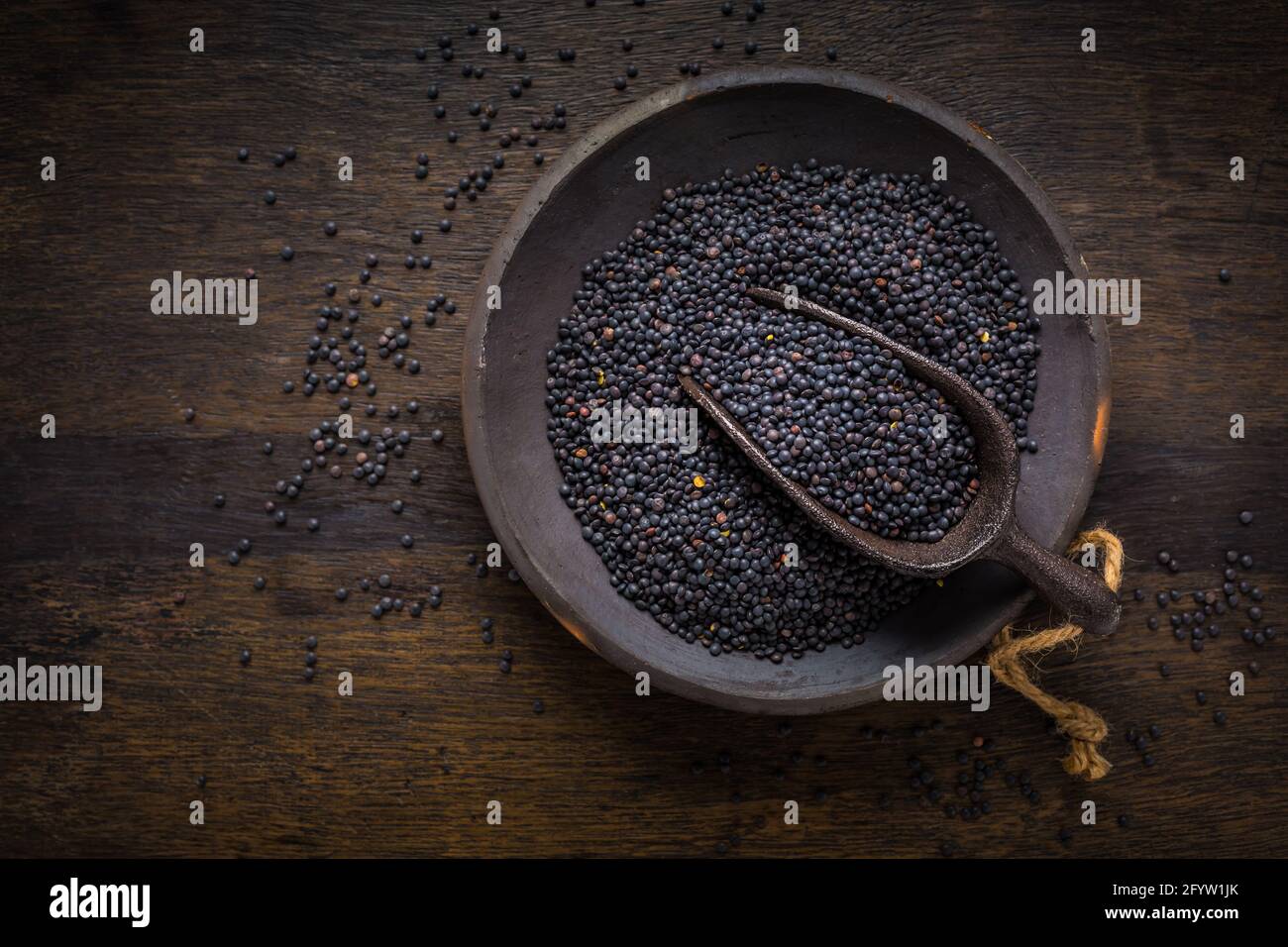 Beluga lentils (Vigna mungo) in bowl on dark wooden background Stock ...