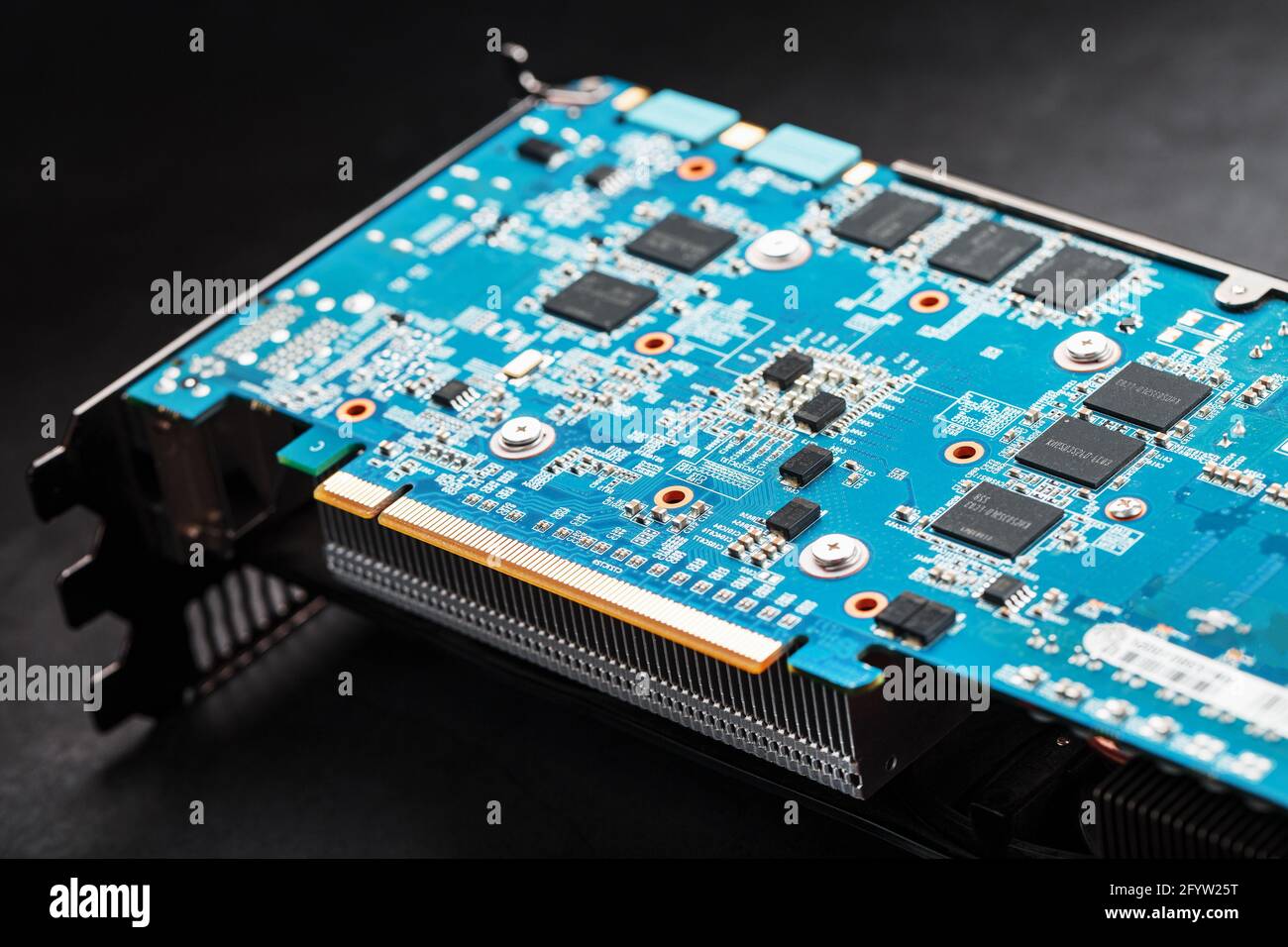A blue board with chips and a gaming graphics card processor ...