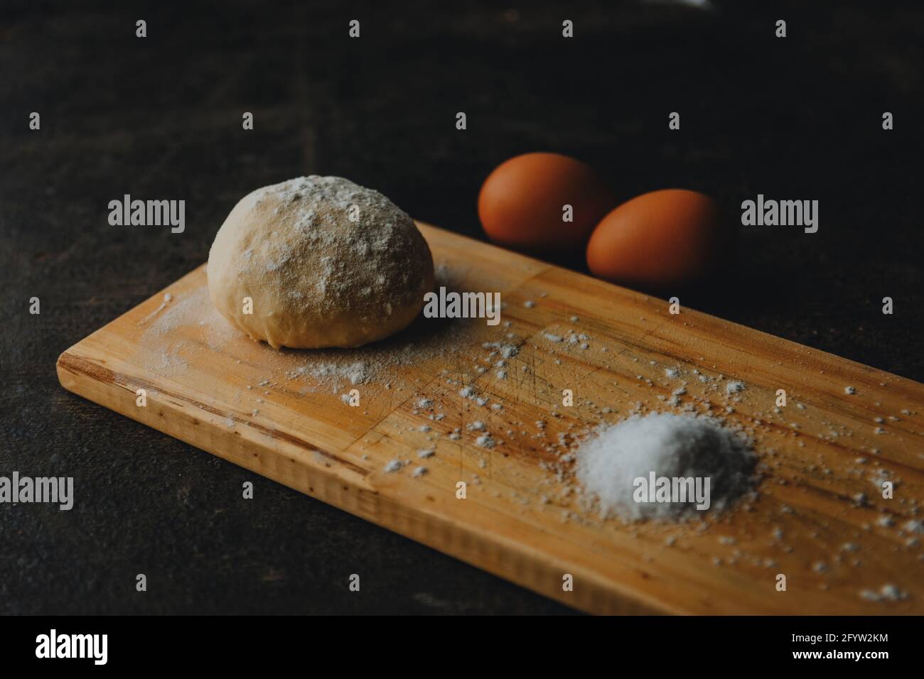 A closeup shot of salt, dough, and eggs on a table Stock Photo - Alamy