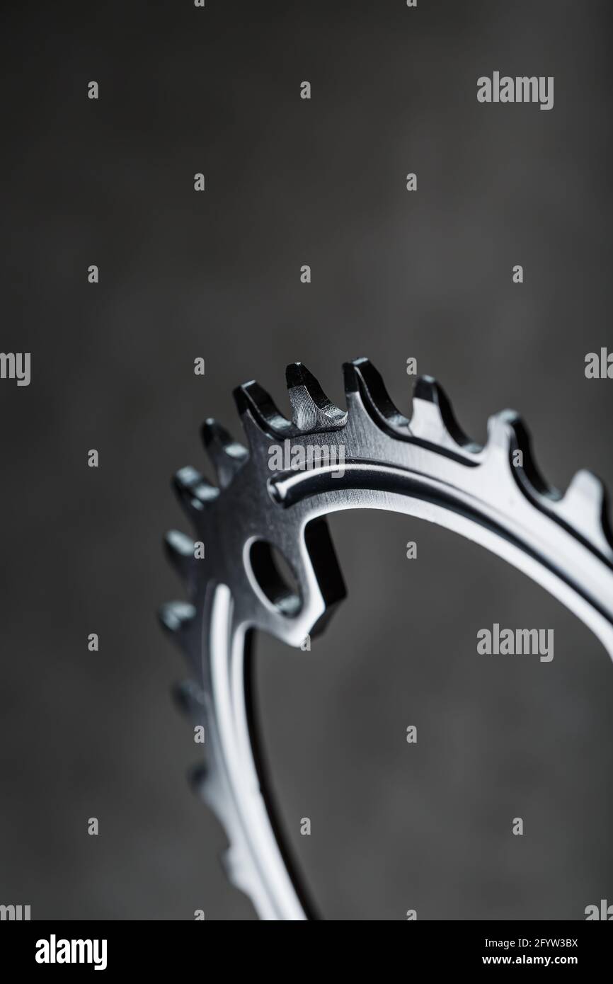The teeth of the bicycle front star system on a dark background ...