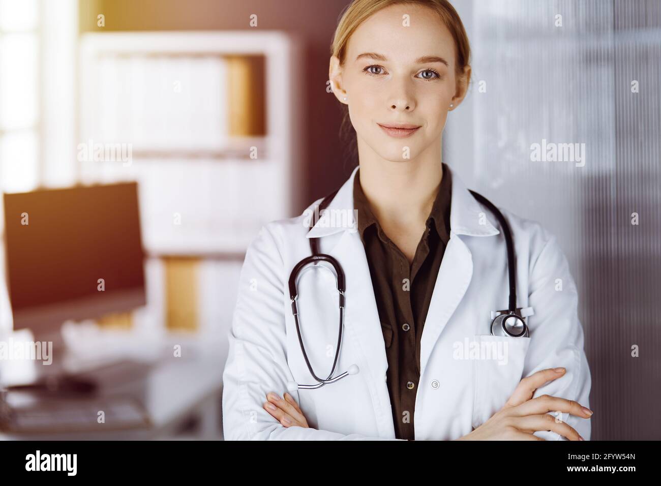 Cheerful Smiling Female Doctor Standing In Clinic Portrait Of Friendly