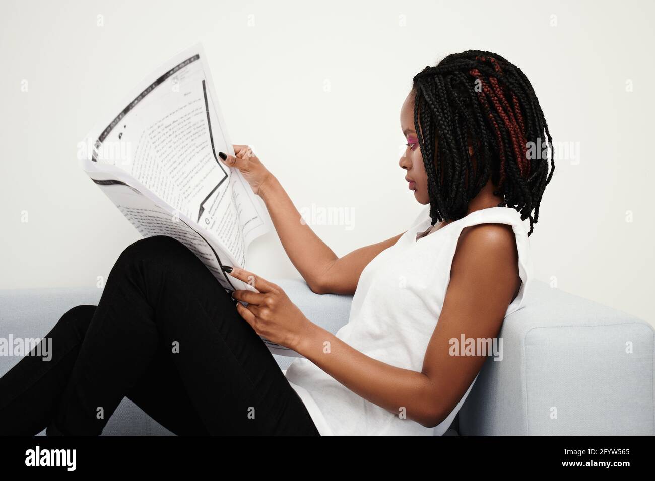 African american girl reading newspaper hi-res stock photography and ...