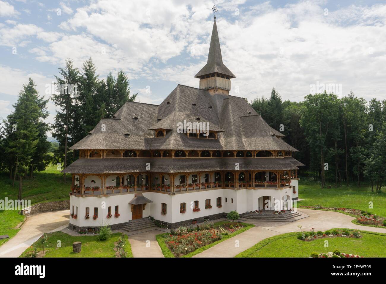The Peri-Sapanta Monastery surrounded by greenery under a cloudy sky in ...