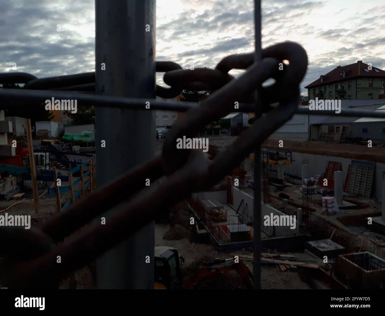 metal chain at urban construction site at sunset, close up Stock Photo ...