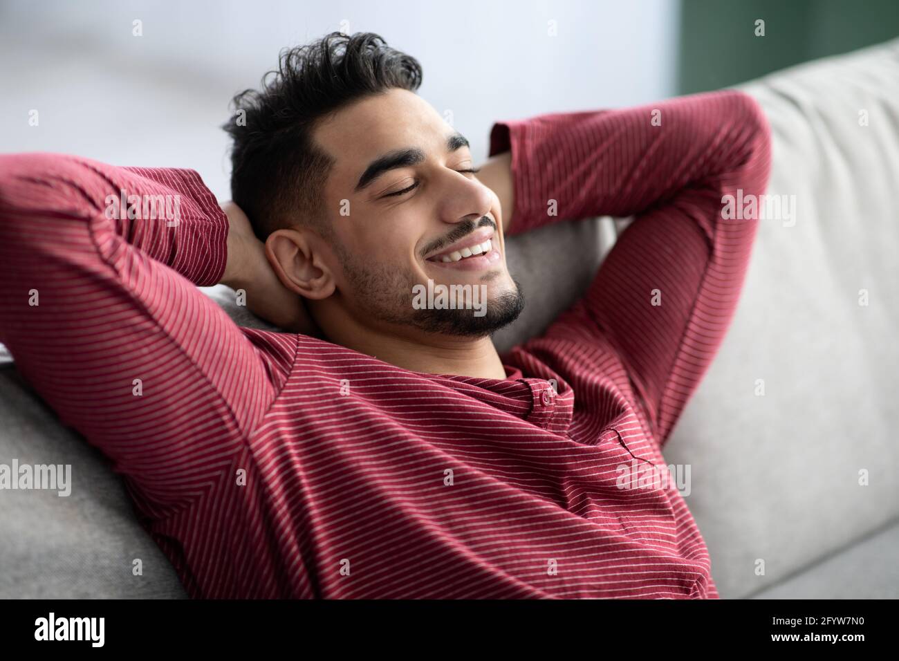 Closeup of peaceful arab guy reclining on couch at home Stock Photo - Alamy