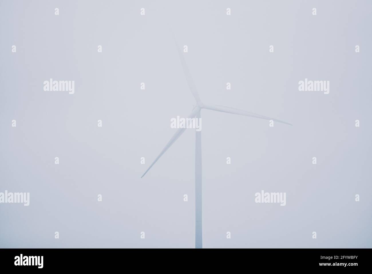 A closeup of a wind turbine in the morning fog Stock Photo - Alamy