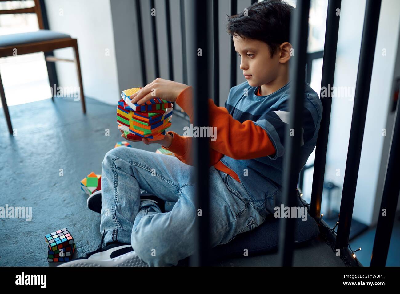 Child trying to solve difficult puzzle cube Stock Photo - Alamy