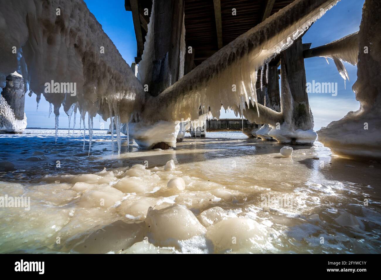 A closeup shot of an icy frozen shore of the lake in frosty winter ...
