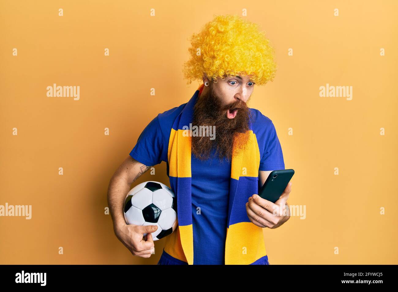 Redhead man with long beard football hooligan cheering game holding ...