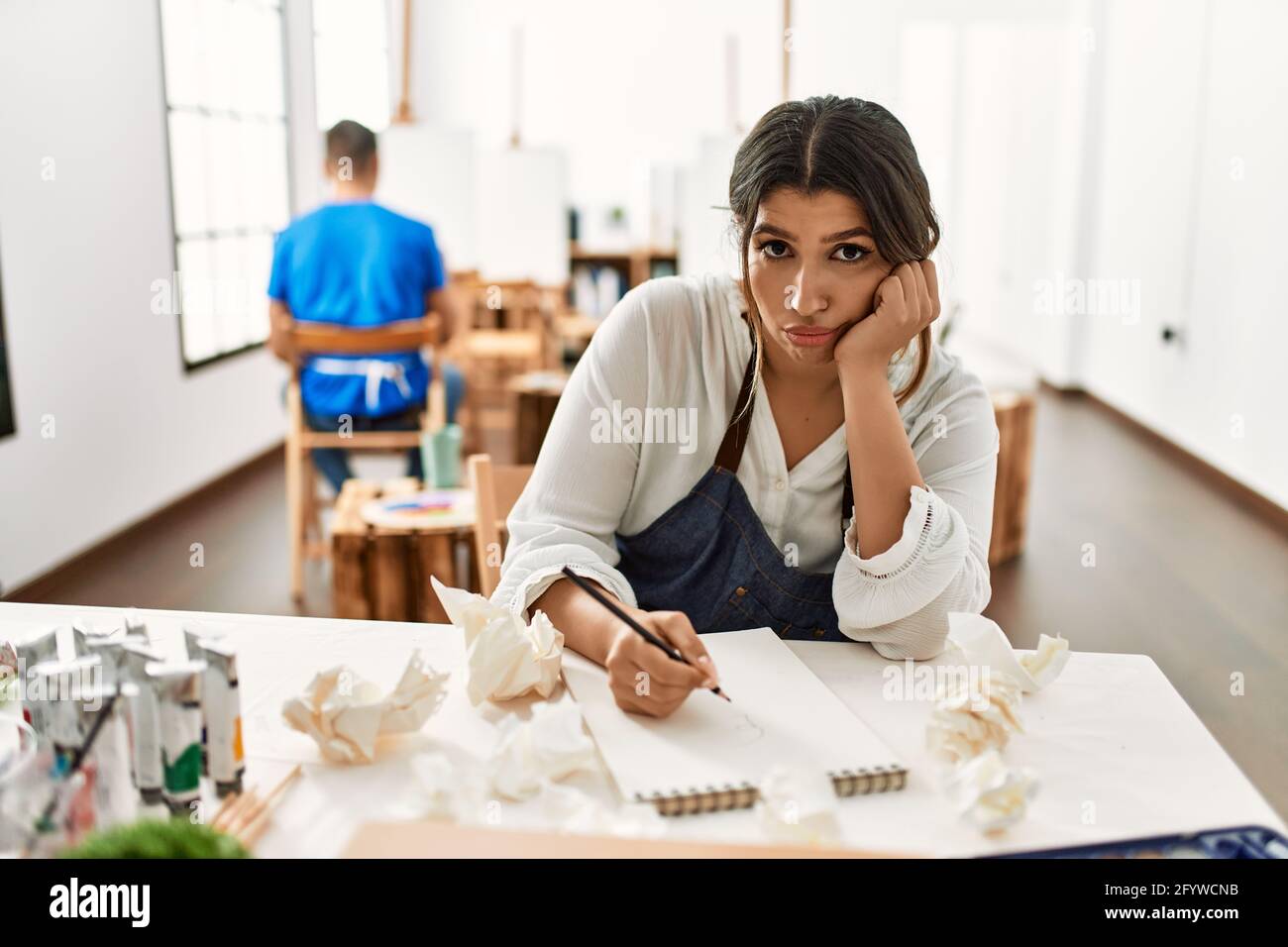 Paint student wpman stressed painting at art school Stock Photo - Alamy