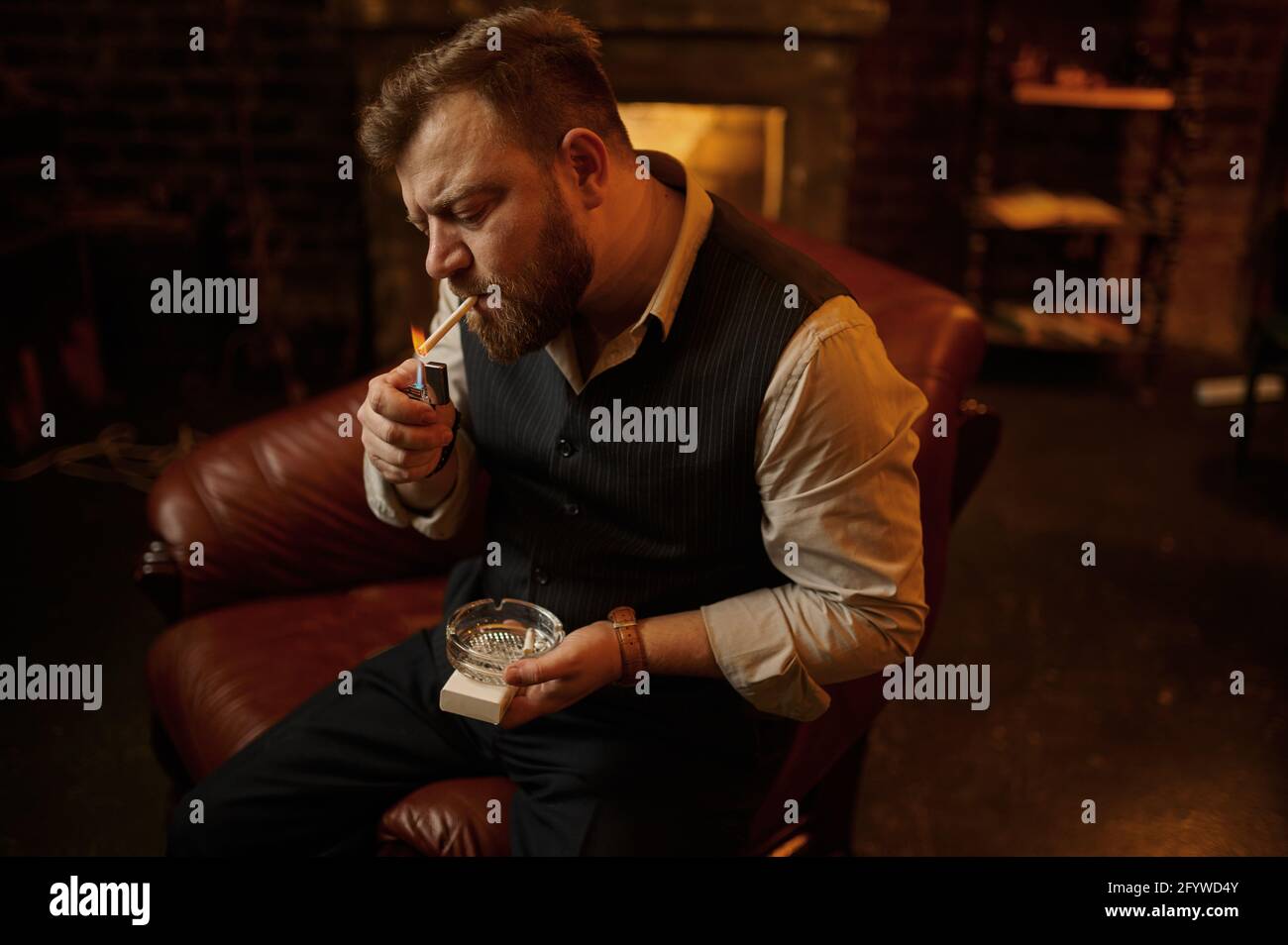 Bearded man lights cigarette hi-res stock photography and images - Alamy