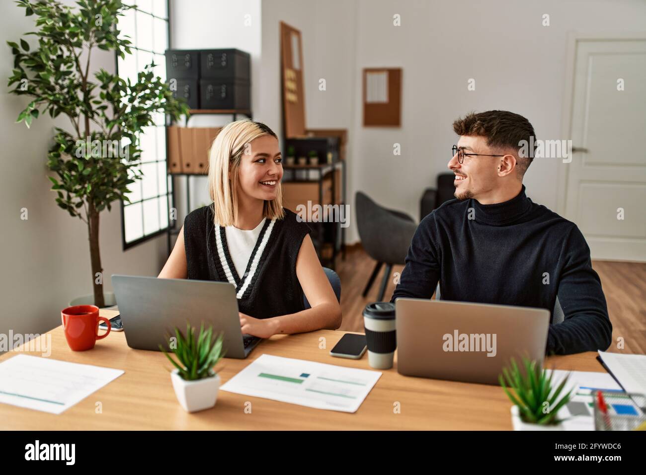 Two business workers smiling happy working at the office Stock Photo ...