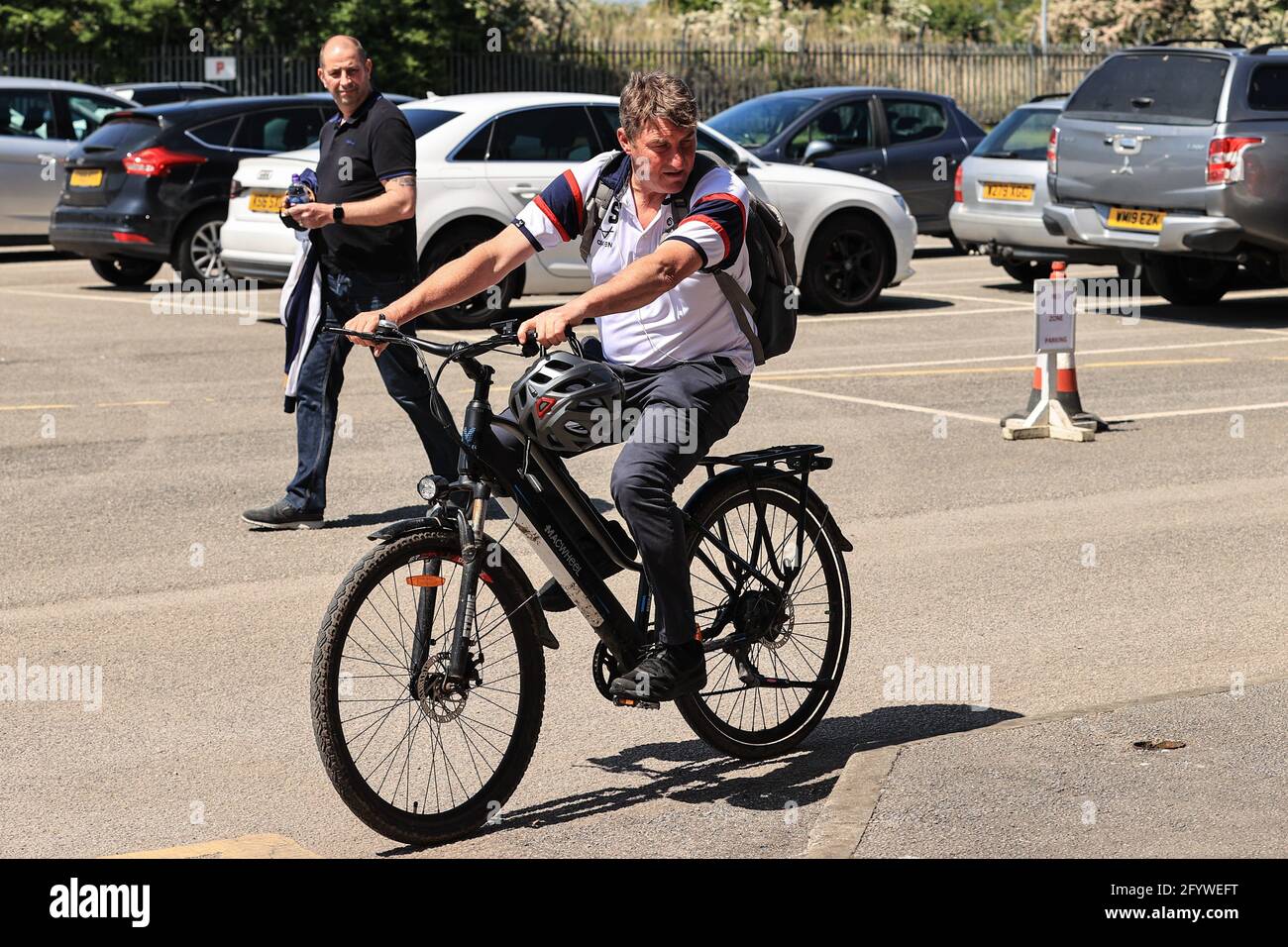 Tony Smith Head Coach of Hull KR arrives at Hull College Craven Park on his electric bike Stock ...