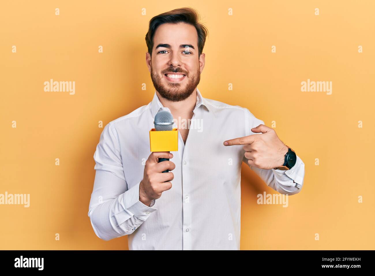 Smiling male journalist holding microphone hi-res stock photography and ...