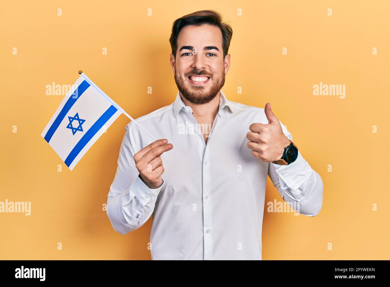 Handsome caucasian man with beard holding israel flag smiling happy and ...