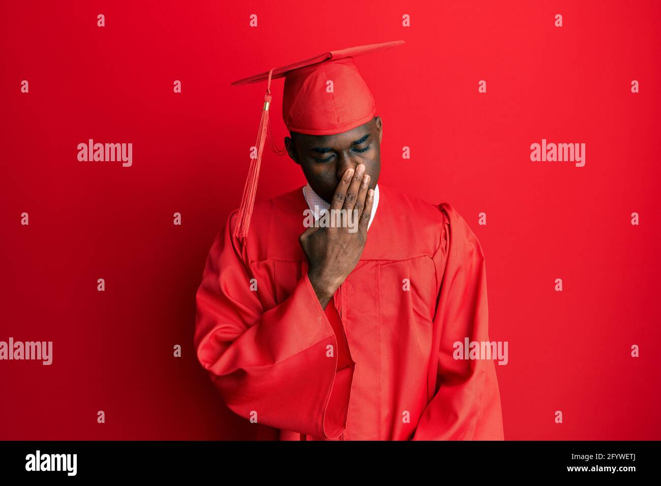 Young african american man wearing graduation cap and ceremony robe ...