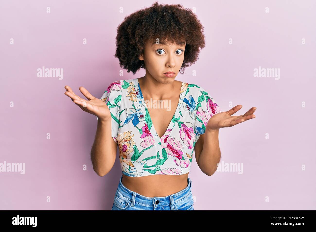 Young hispanic girl wearing summer style clueless and confused with ...