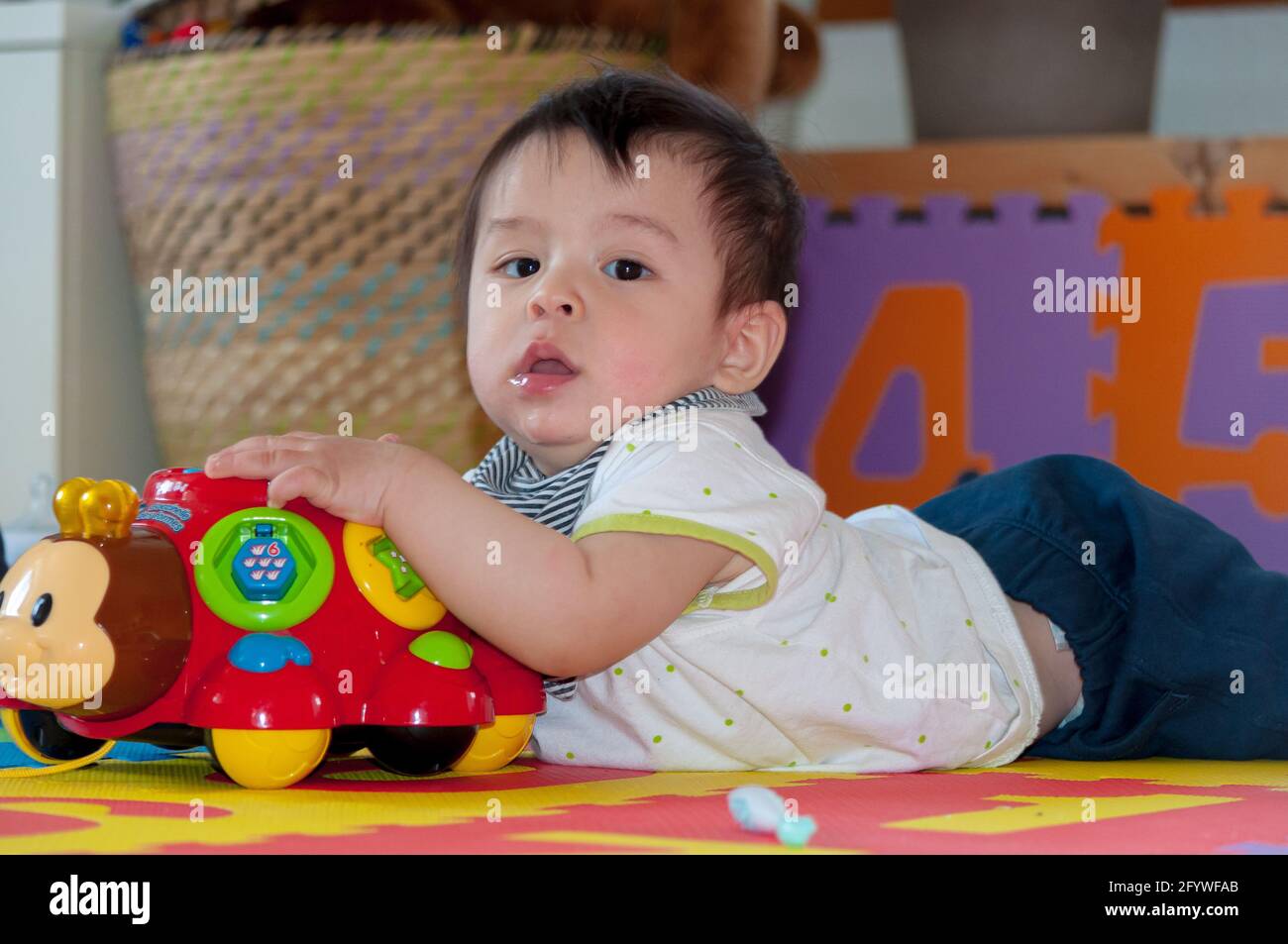 A cute little boy playing with a toy car at home Stock Photo - Alamy
