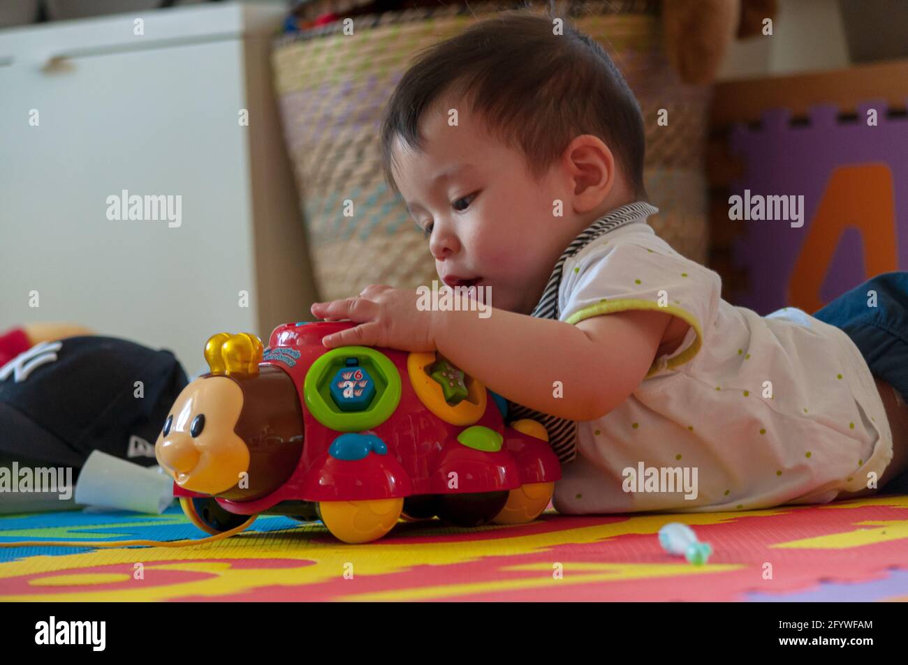 A cute little boy playing with a toy car at home Stock Photo - Alamy