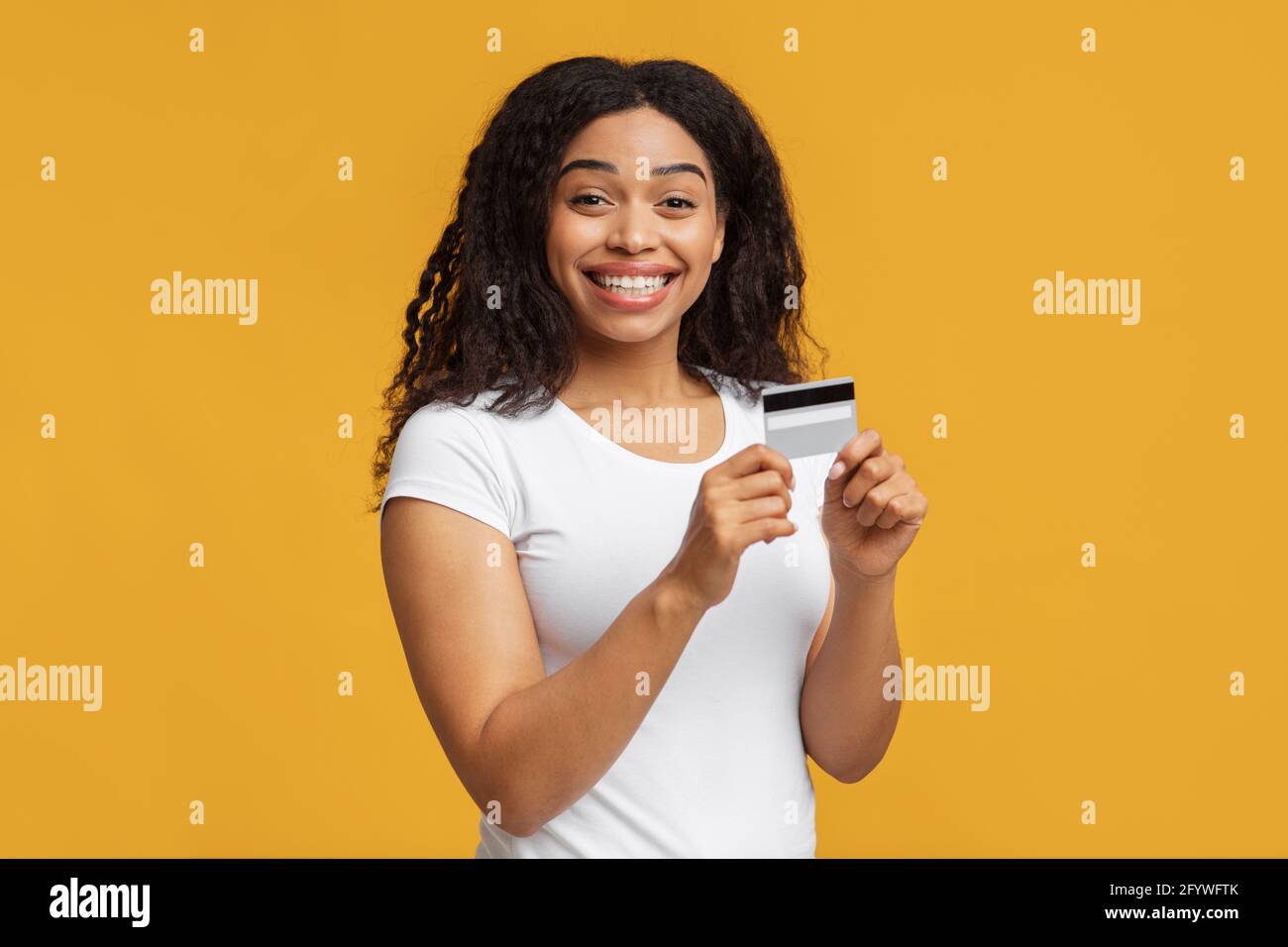 Easy digital cashless payment. Happy black woman holding credit card ...