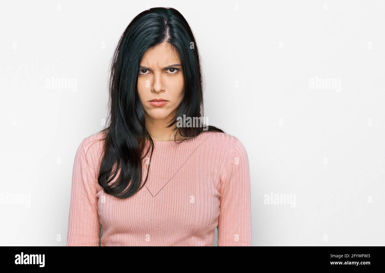 Young hispanic woman wearing casual clothes skeptic and nervous ...