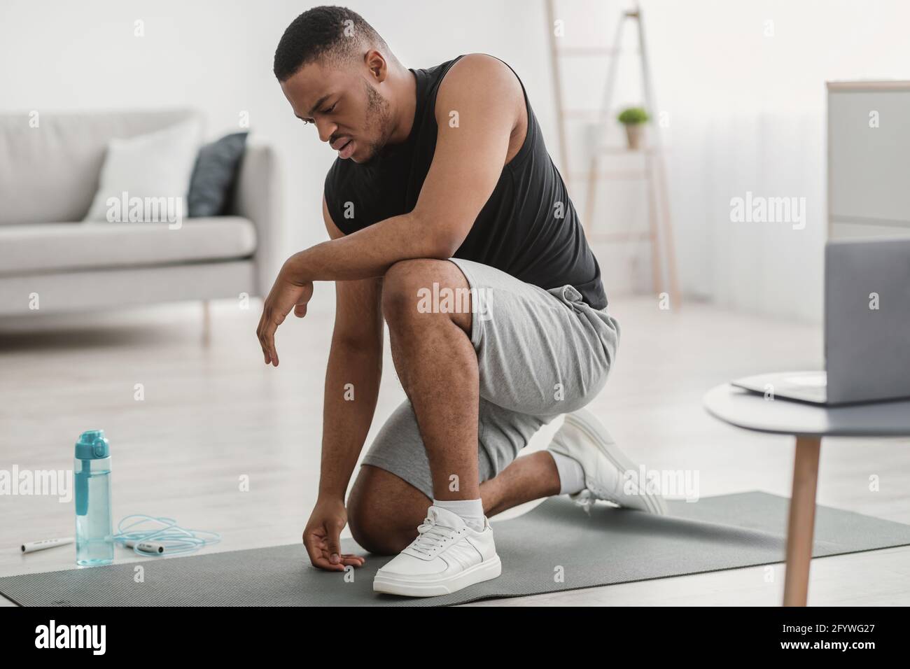African Fitness Guy Feeling Bad During Online Training At Home Stock ...