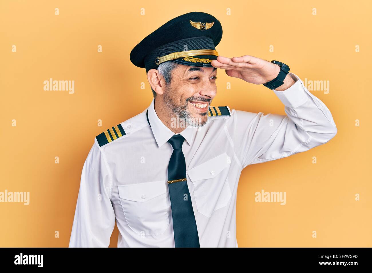 Handsome middle age man with grey hair wearing airplane pilot uniform ...