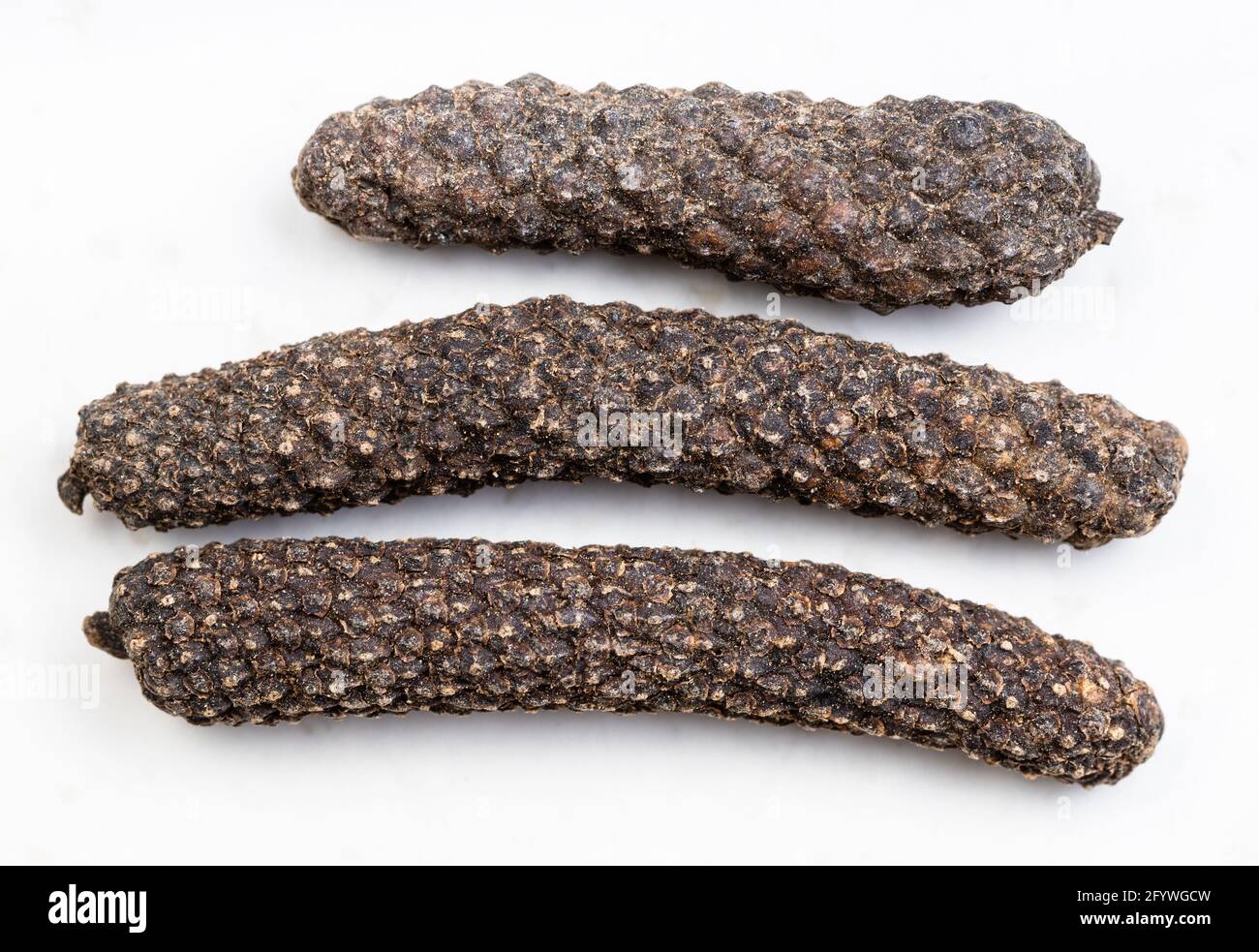 few java long peppers close up on gray ceramic plate Stock Photo - Alamy