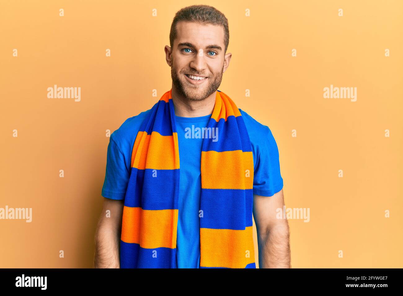 Young caucasian man football hooligan cheering game with a happy and ...