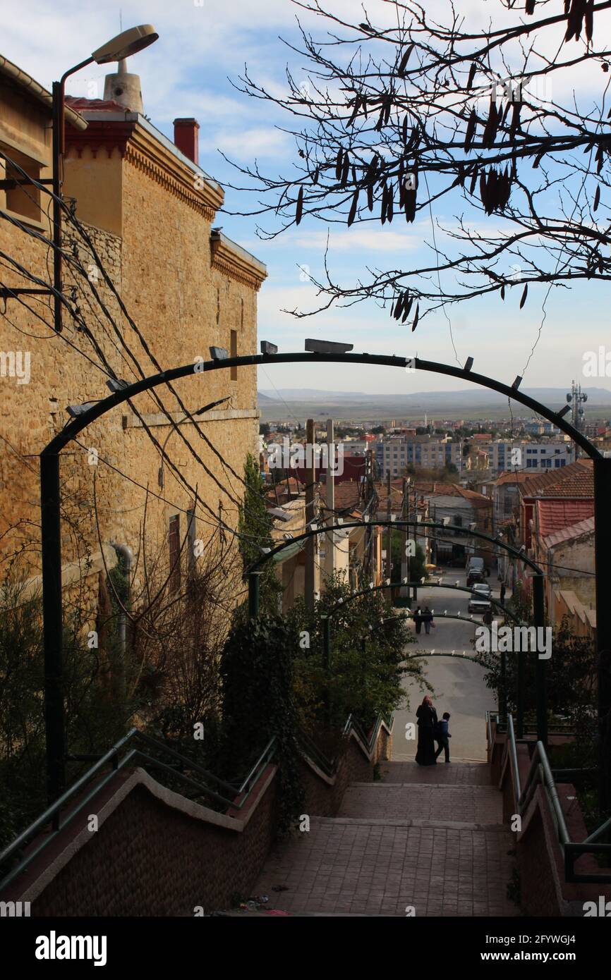 A high gate with a staircase down to take to a popular neighborhood in ...