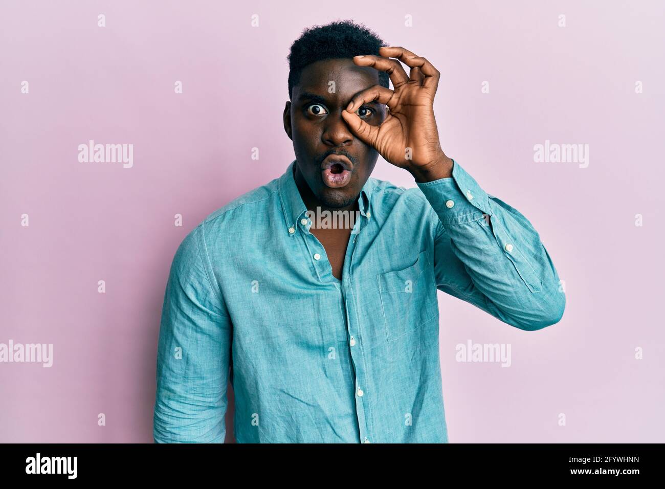 Handsome black man wearing casual clothes doing ok gesture shocked with ...