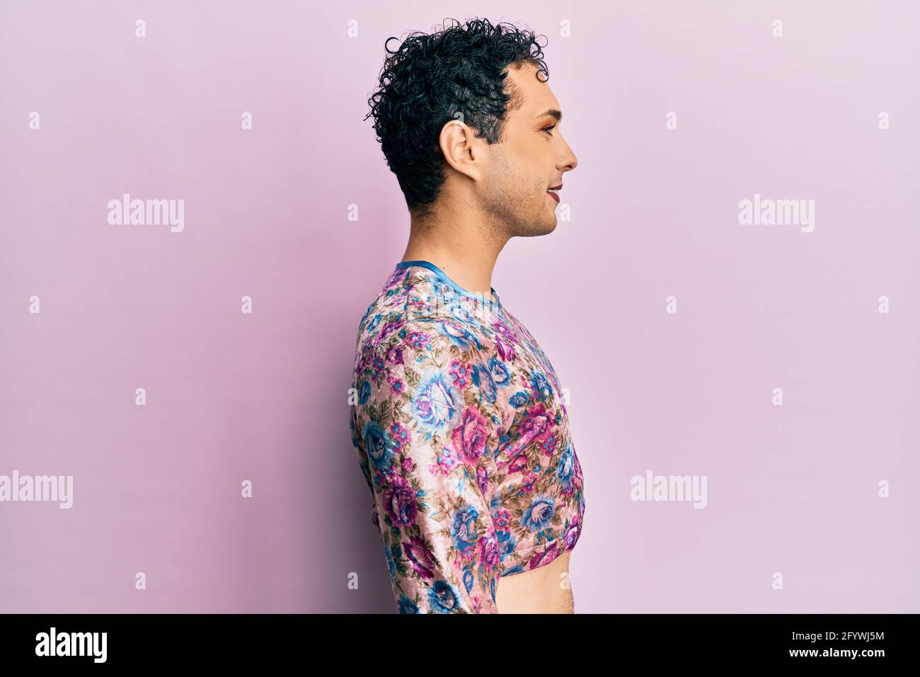 Handsome man wearing make up wearing fashion clothes looking to side ...